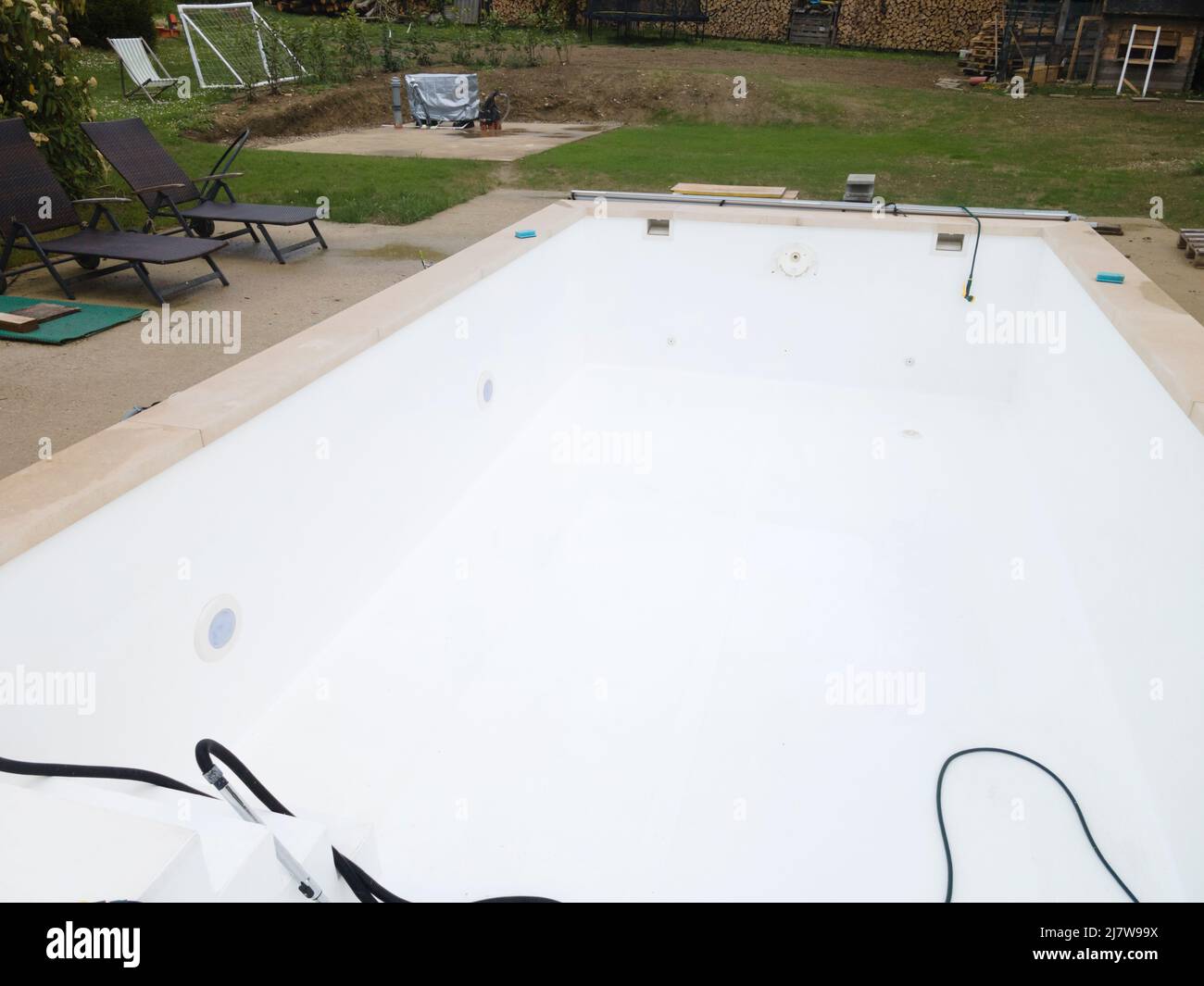 Drone flight over pool in the middle of greenery just left out and ...