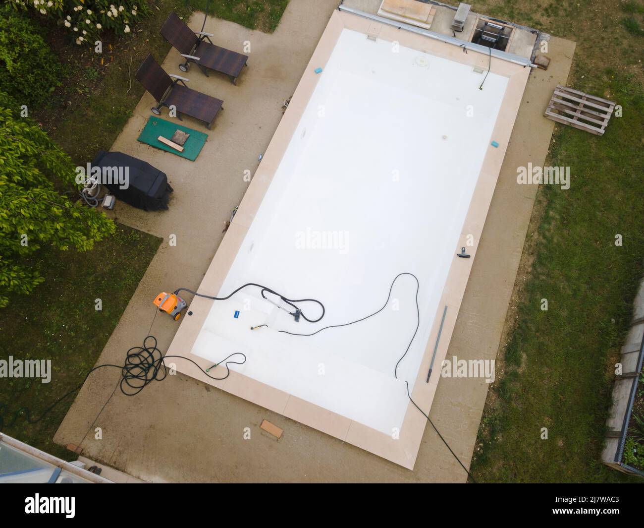 Drone flight over pool in the middle of greenery just left out and ...