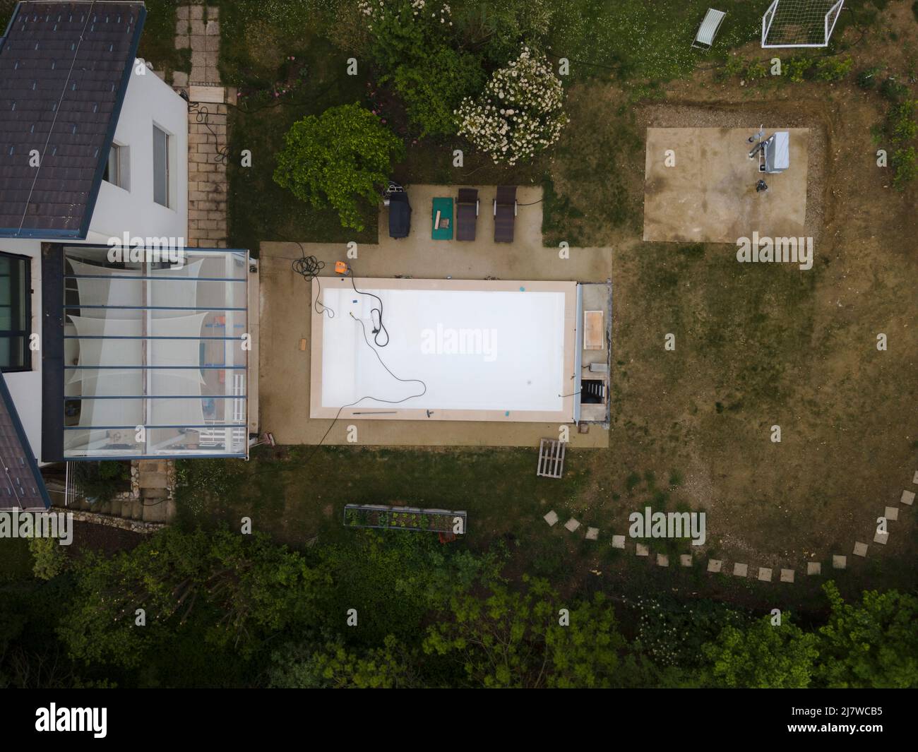 Drone flight over pool in the middle of greenery just left out and ...