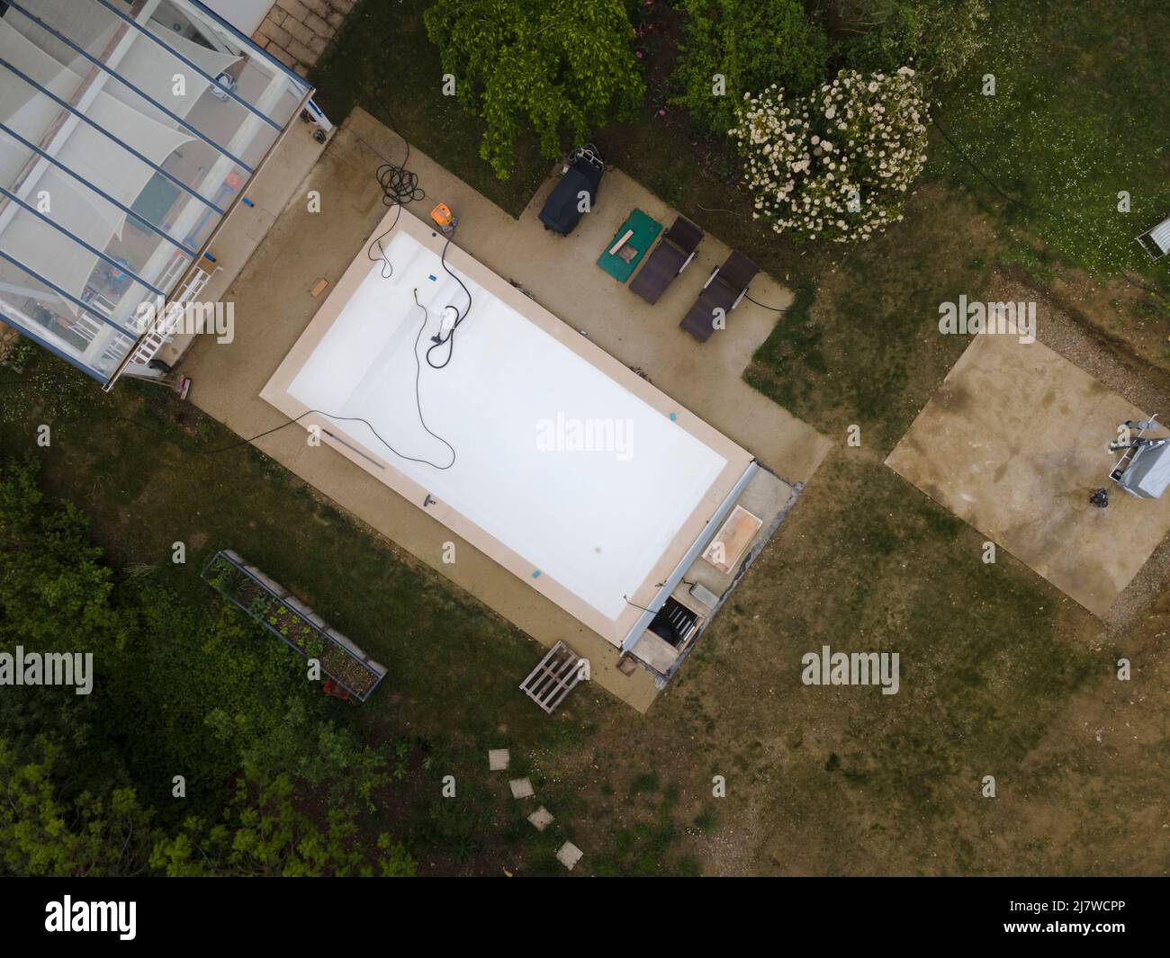 Drone flight over pool in the middle of greenery just left out and ...