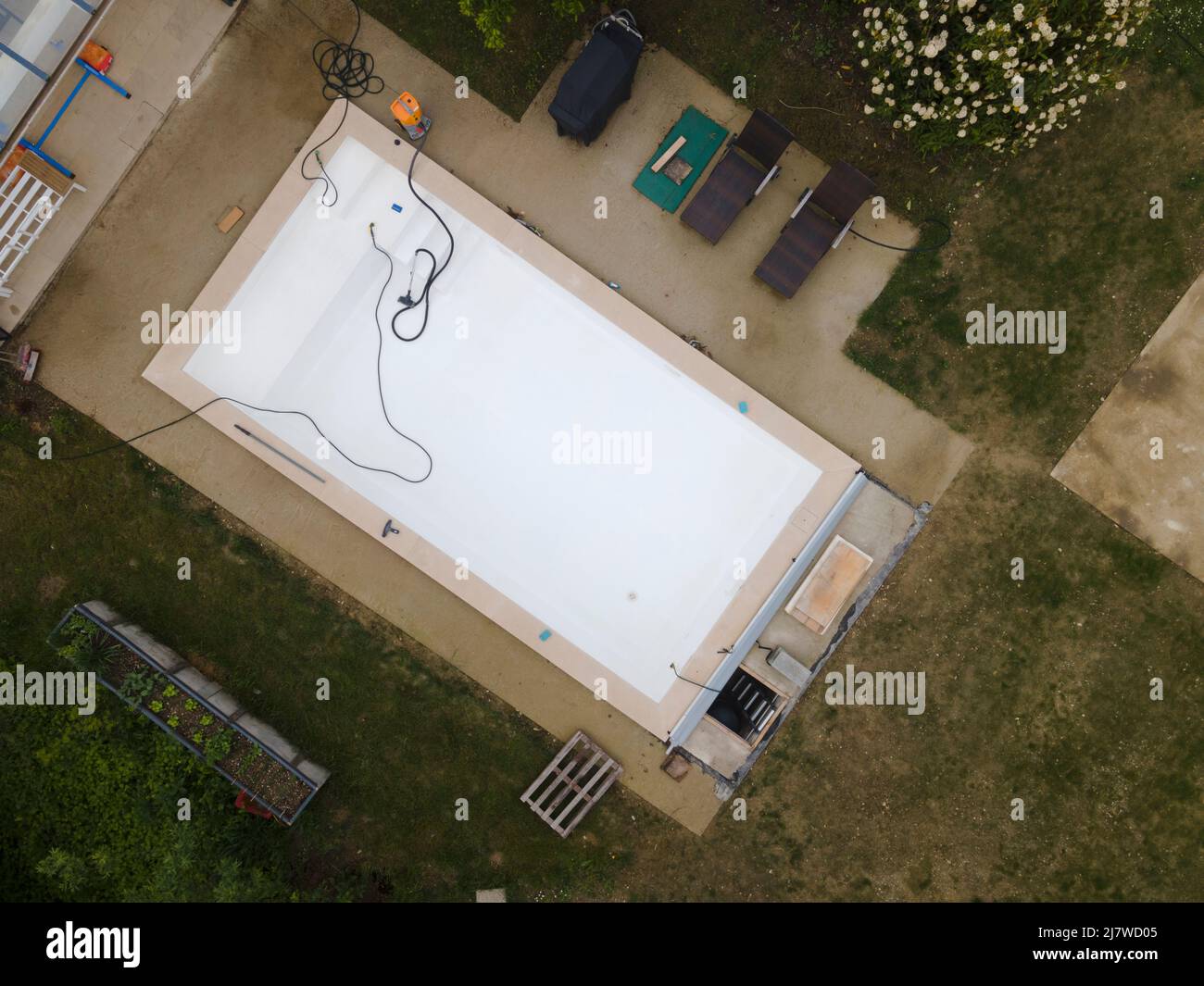 Drone flight over pool in the middle of greenery just left out and ...