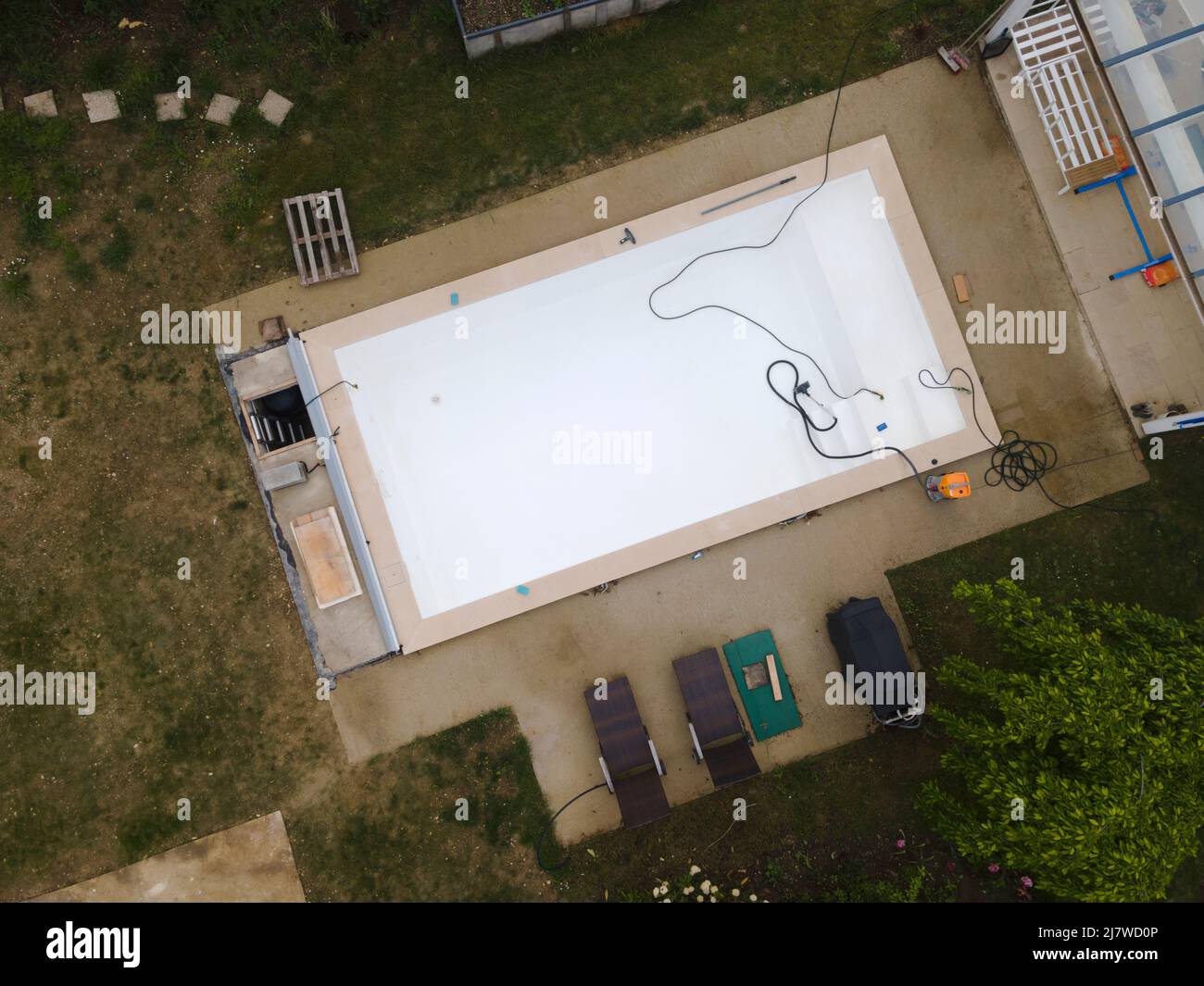 Drone flight over pool in the middle of greenery just left out and ...