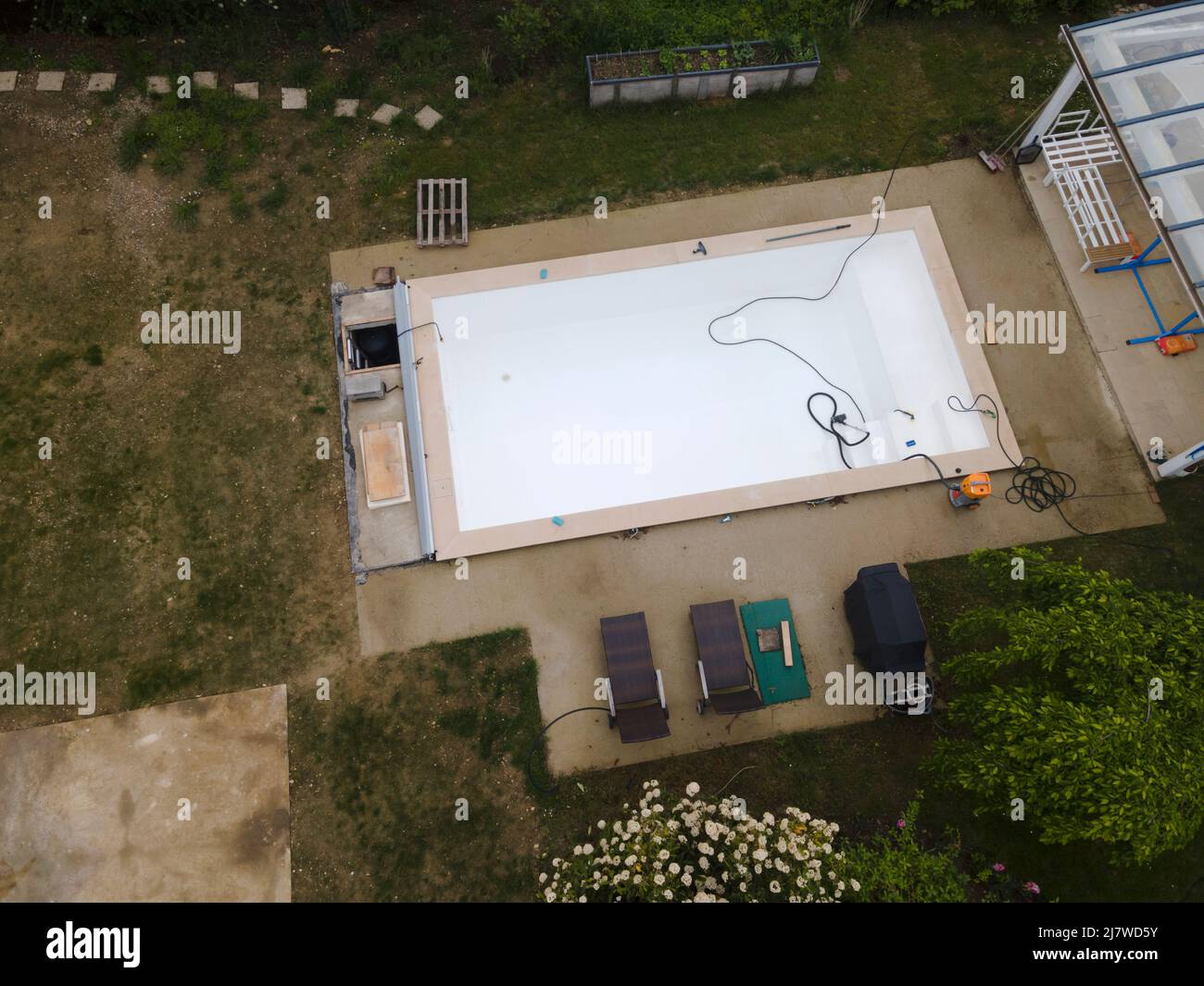 Drone flight over pool in the middle of greenery just left out and ...