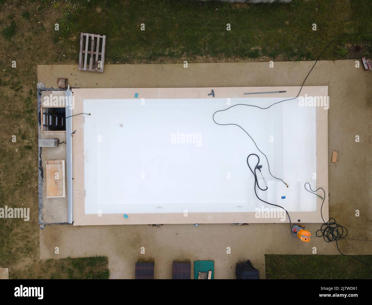 Drone flight over pool in the middle of greenery just left out and ...