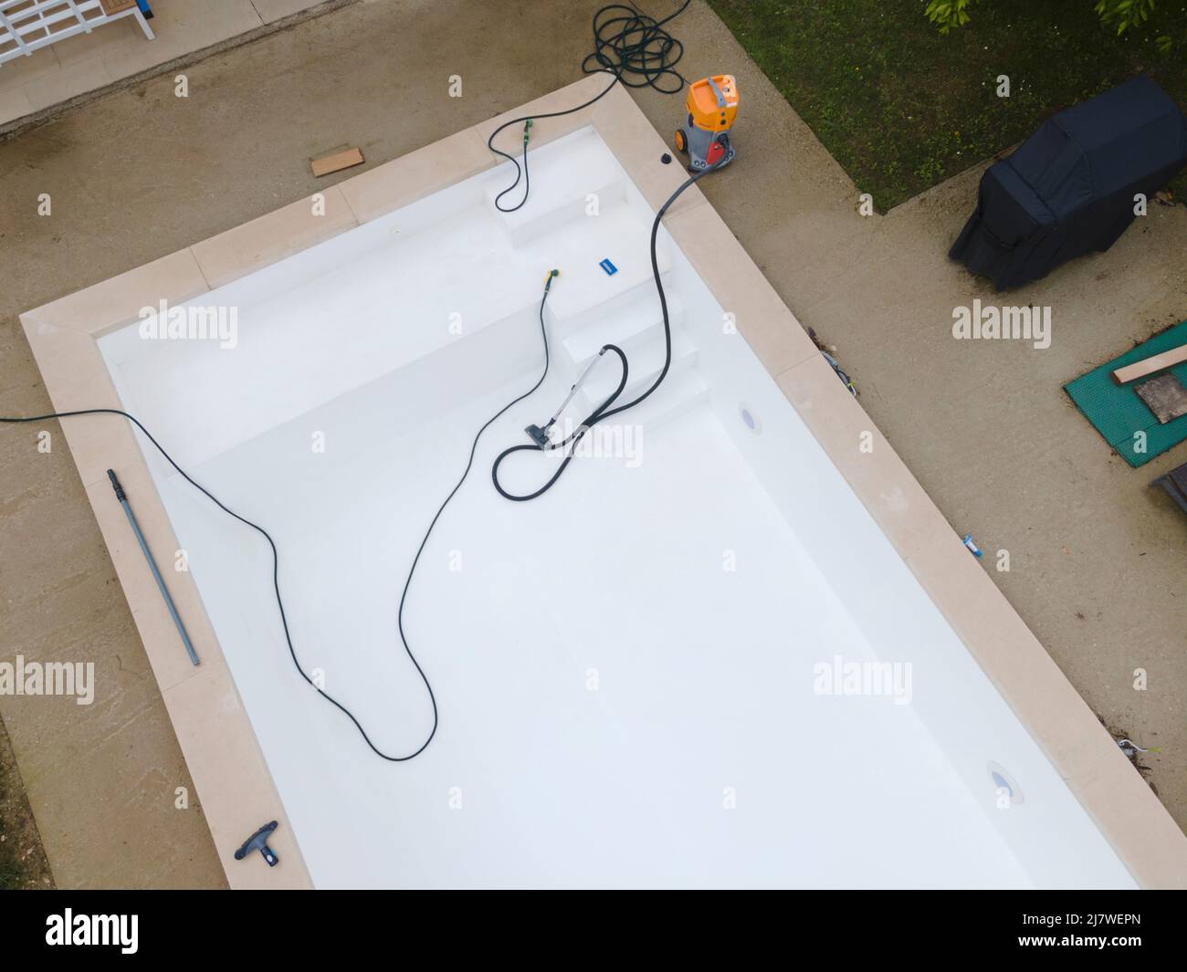 Drone flight over pool in the middle of greenery just left out and ...