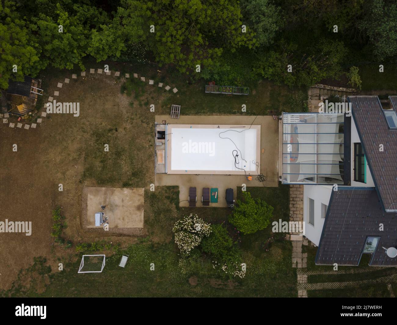 Drone flight over pool in the middle of greenery just left out and ...