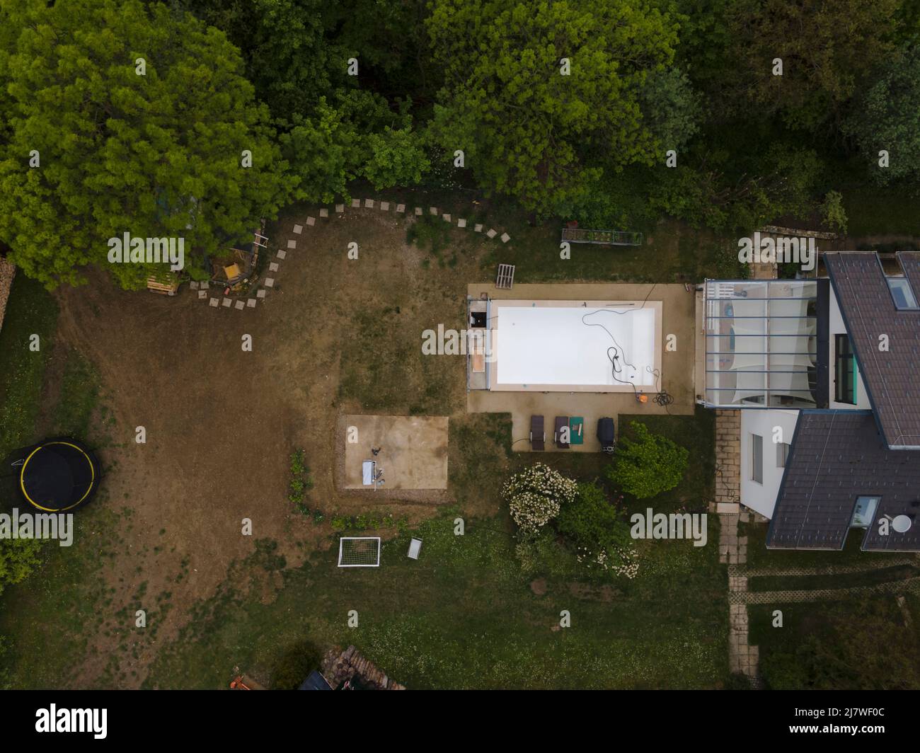 Drone flight over pool in the middle of greenery just left out and ...