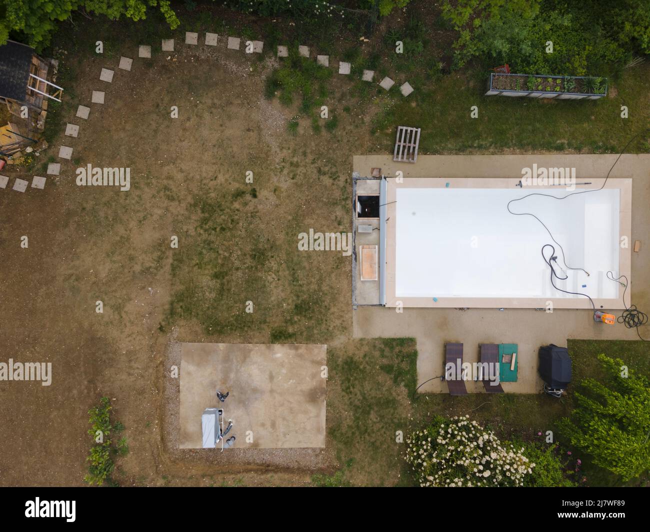 Drone flight over pool in the middle of greenery just left out and ...