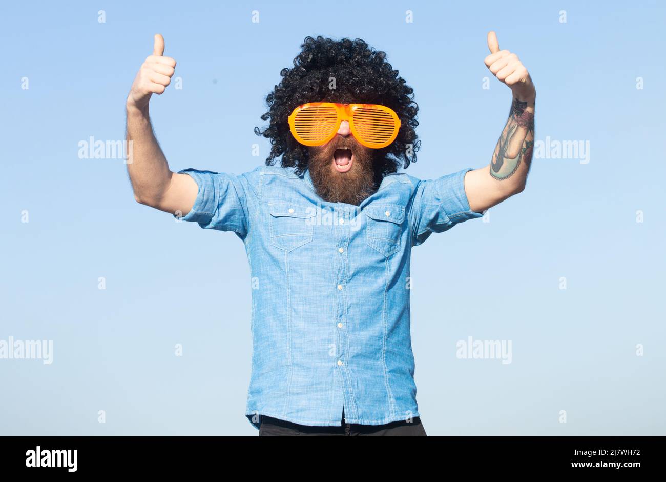 Funny man with large glasses. Crazy funny bearded man with wig and fun ...