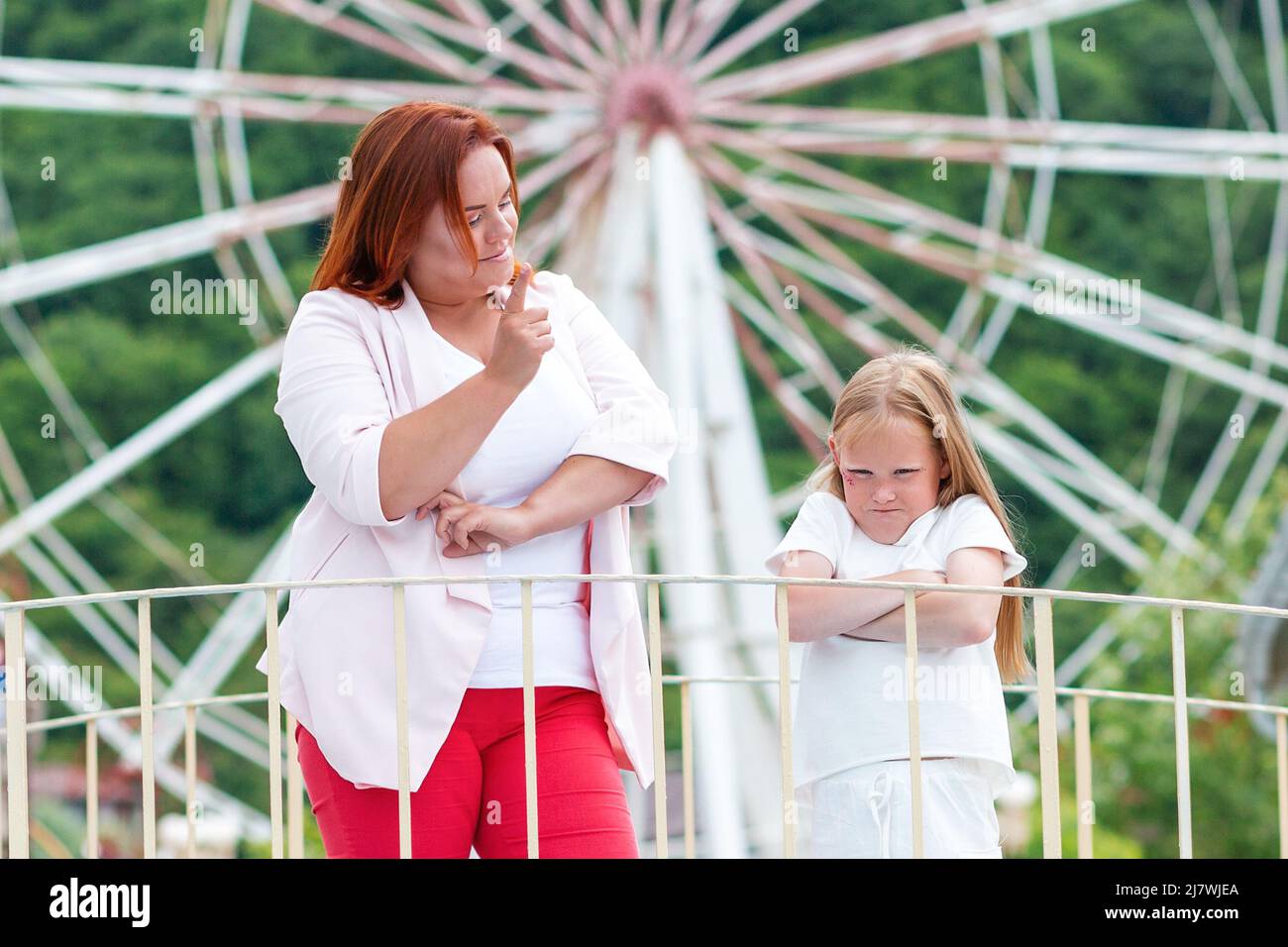 Family portrait. The mother shakes her finger at her daughter for her ...