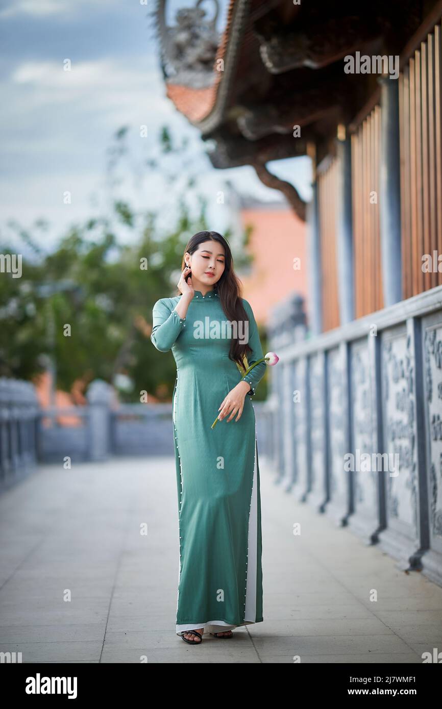 Ho Chi Minh city, Viet Nam: Vietnamese girl going to pagoda in ao dai ...