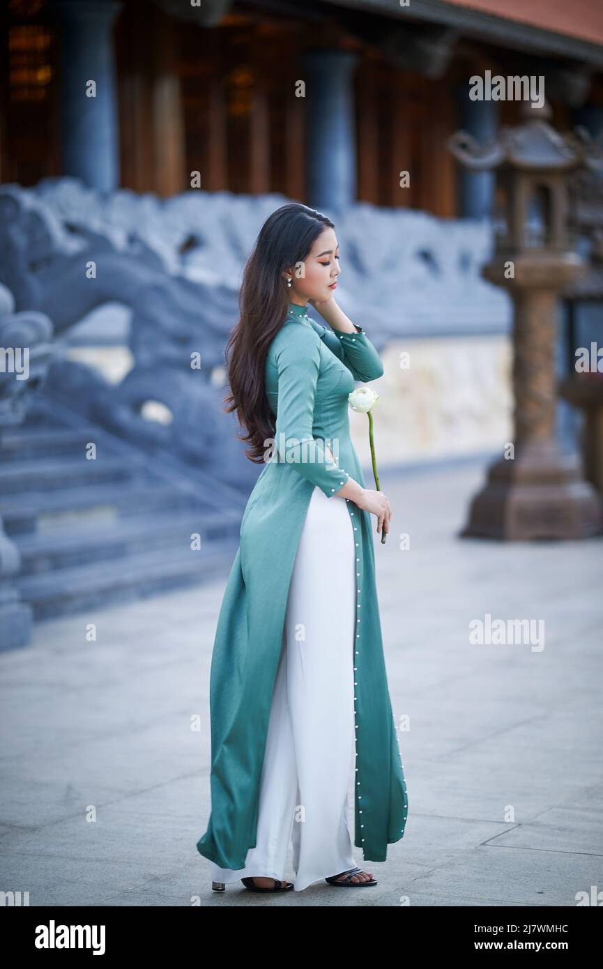 Ho Chi Minh city, Viet Nam: Vietnamese girl going to pagoda in ao dai ...