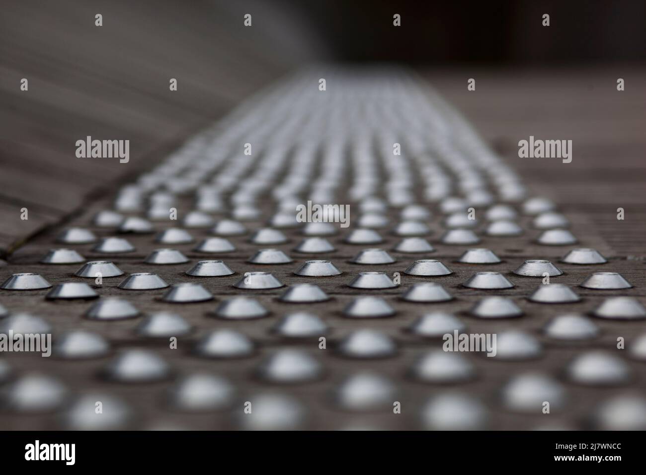 Circular rivets in wood deck Stock Photo - Alamy