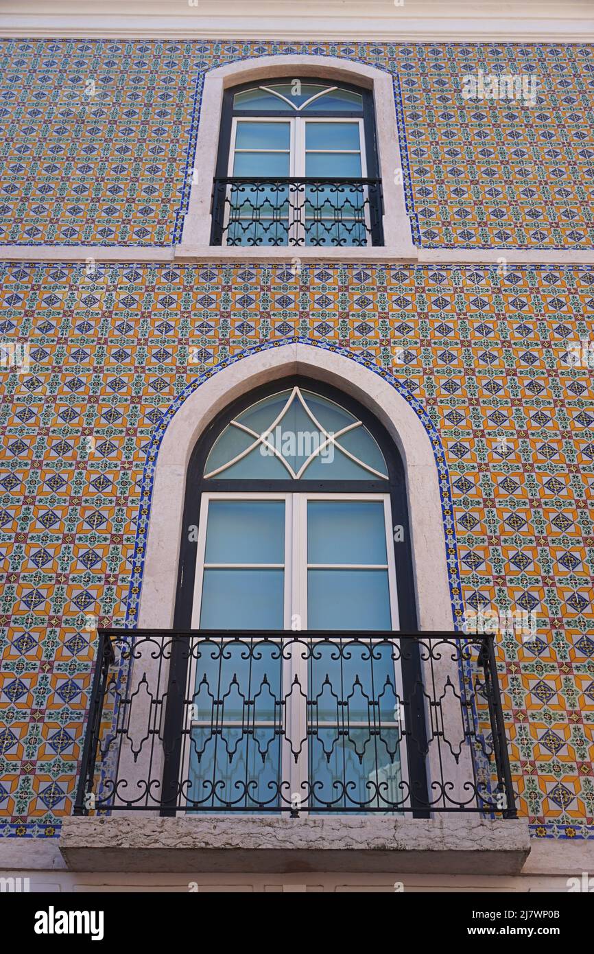 The windows of a typical Portuguese building covered with multicolored ...