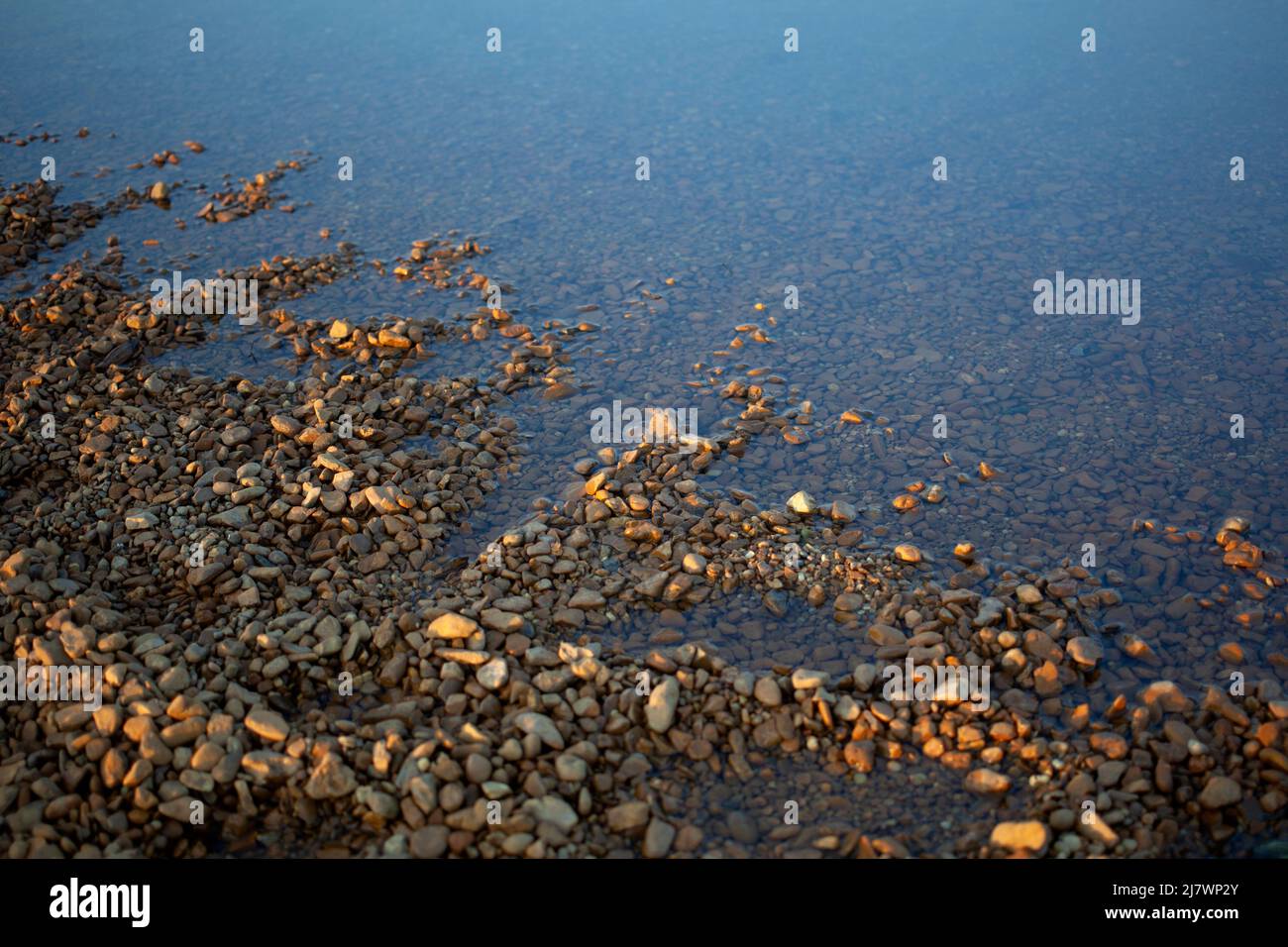 Rocks and pebbles by the water Stock Photo - Alamy