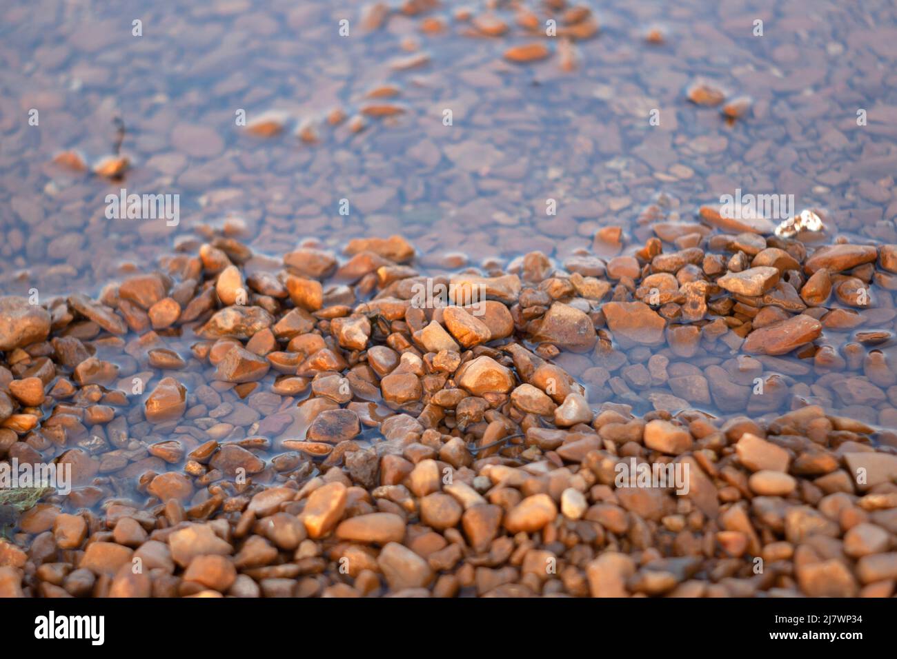 Rocks and pebbles by the water Stock Photo - Alamy