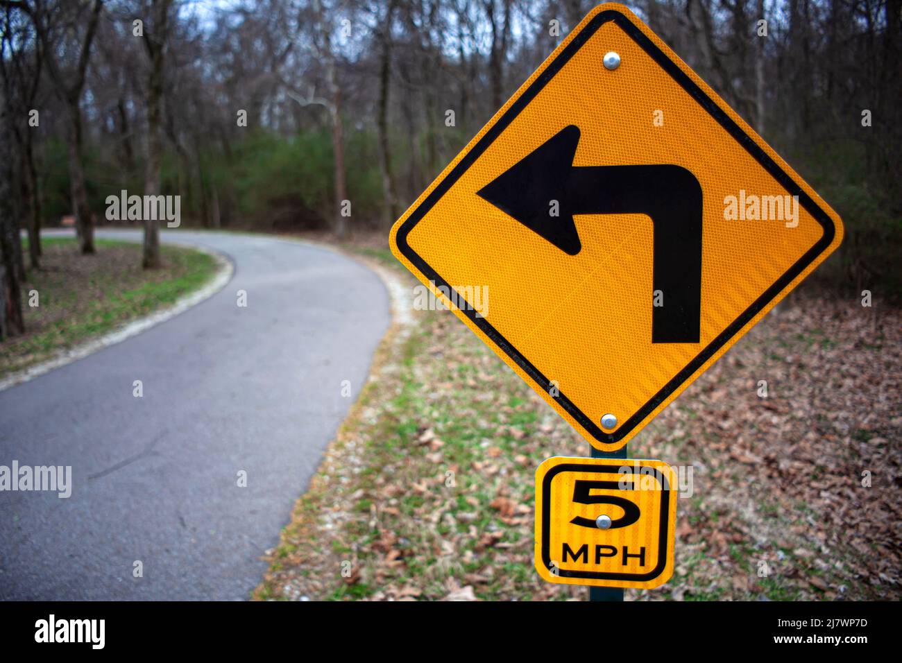 Yellow Left turn ahead sign Stock Photo - Alamy