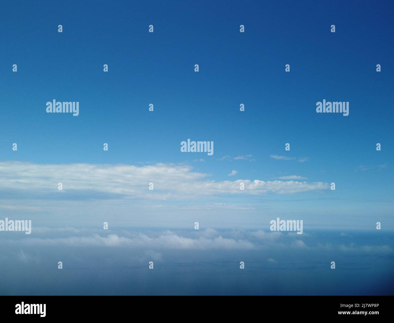 Aerial view. Blue sky sun and fog over calm sea. The drone flies over ...