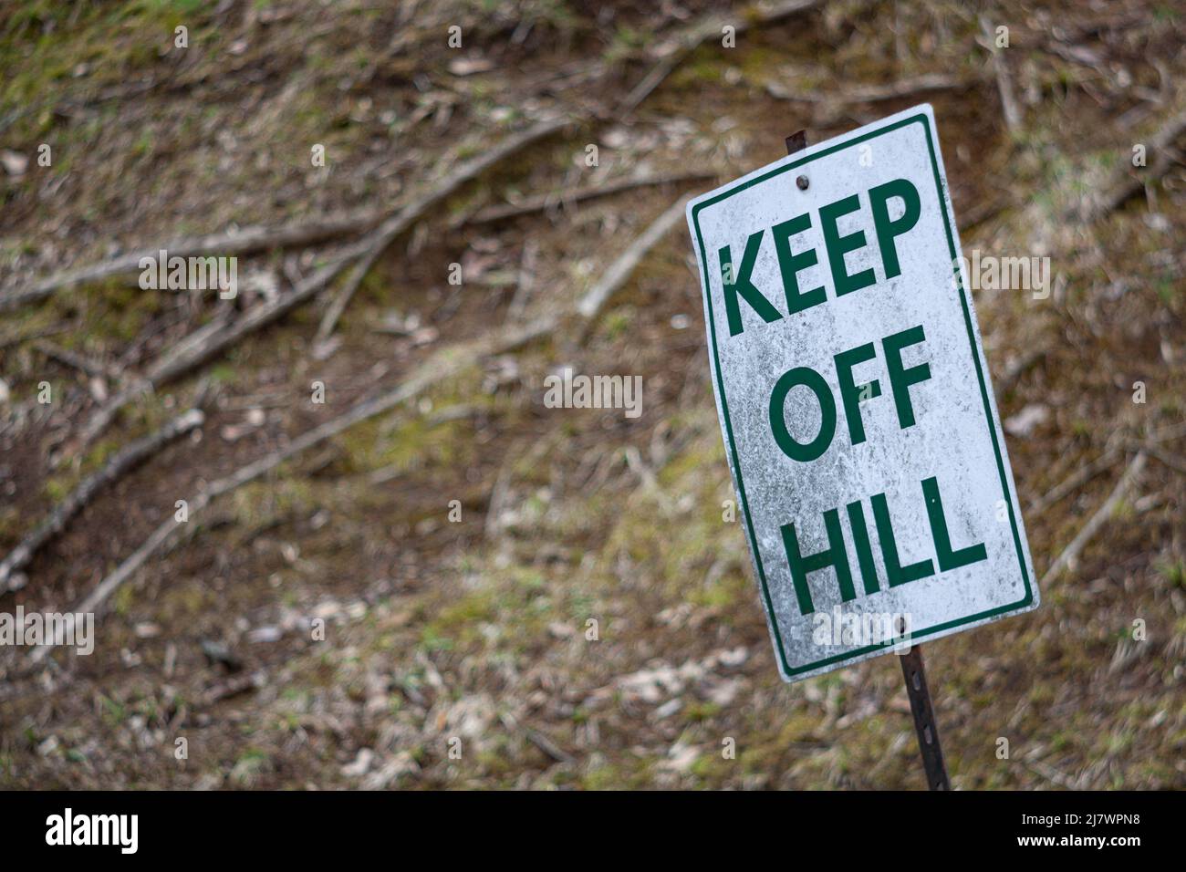 Tilted, "Keep off hill" sign Stock Photo - Alamy