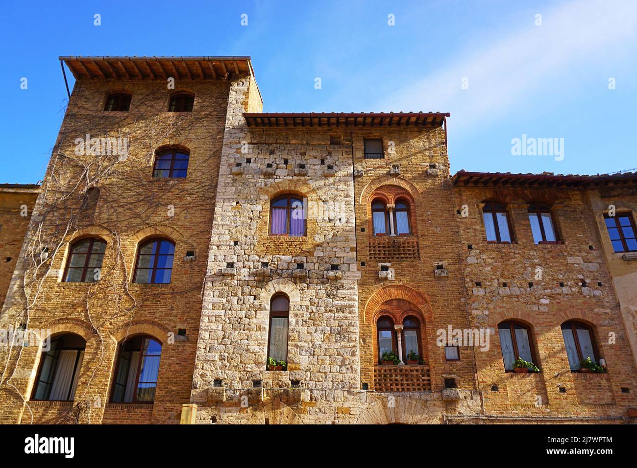 Traditional stone row houses in the town of San Gimignano Stock Photo ...