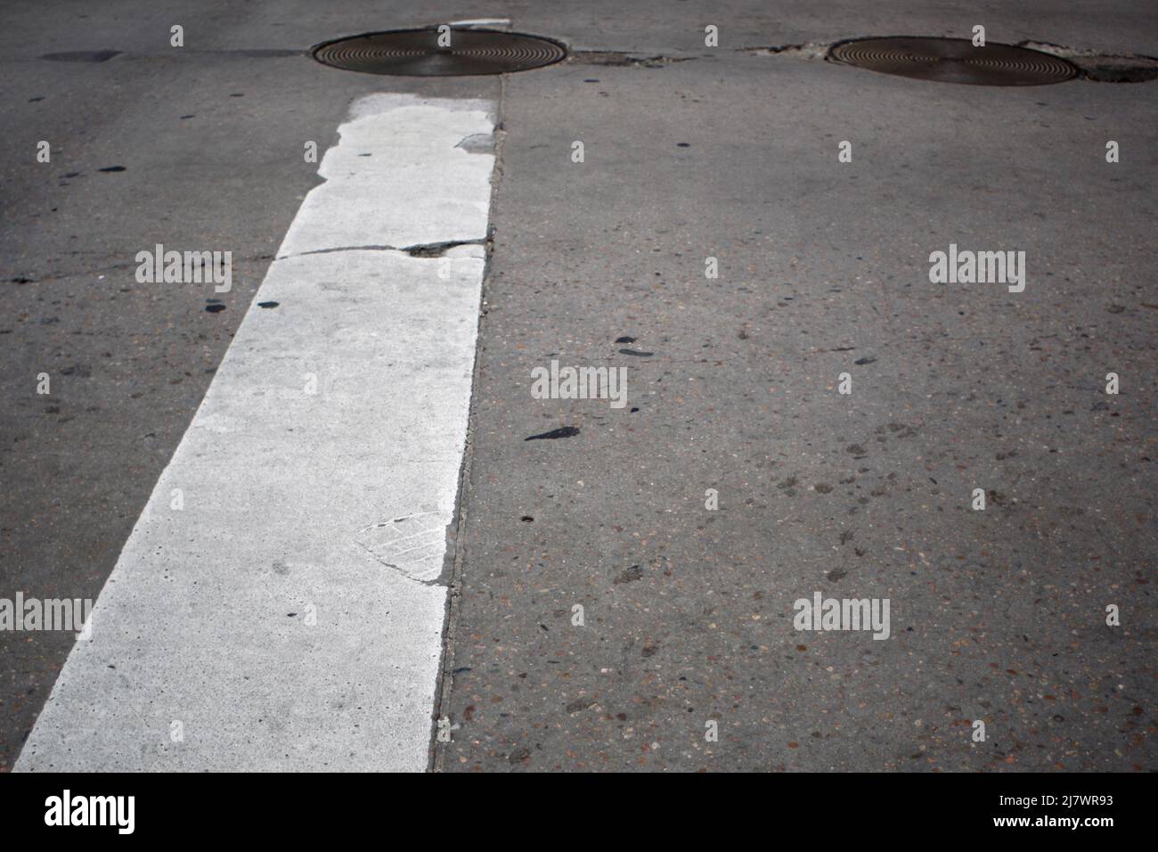 Street Cross Walk with manhole covers Stock Photo - Alamy