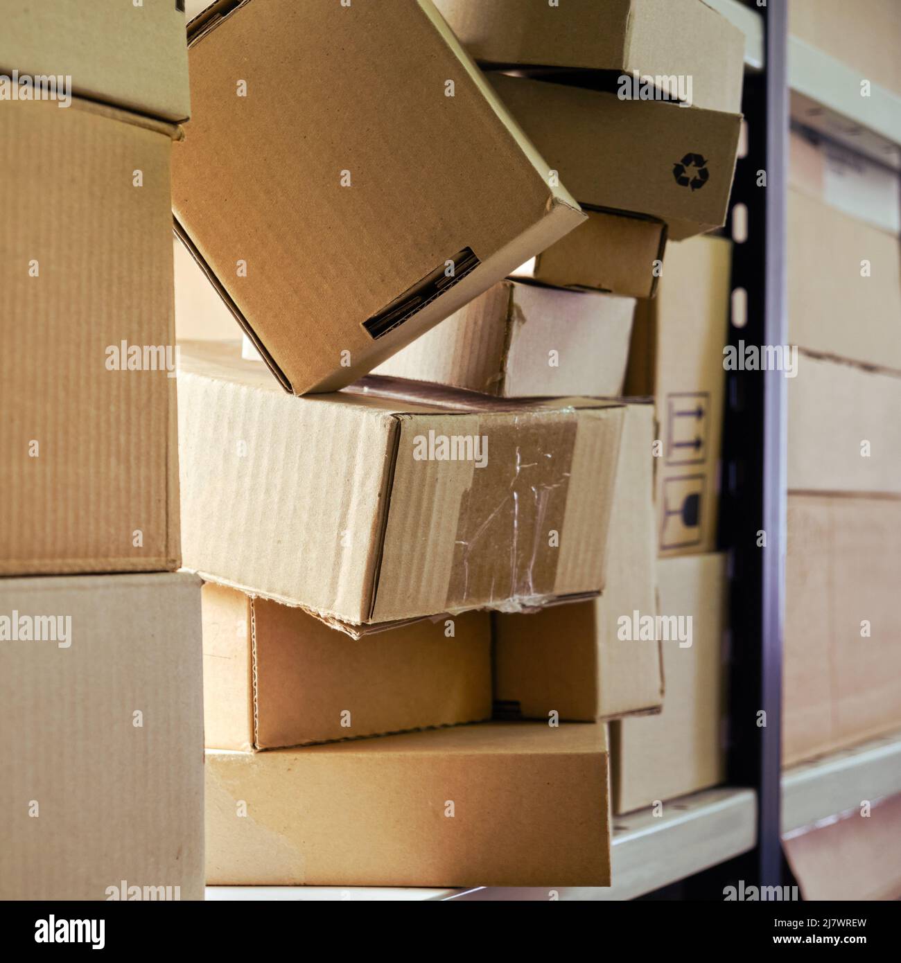 Warehouse overflowing with boxes of goods and postal parcels. Cardboard ...