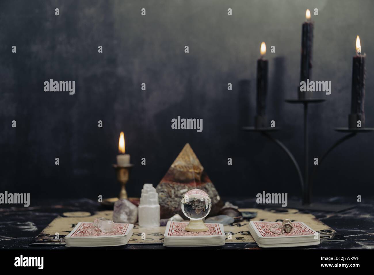 Mystic ritual with Ouija and candles. Devil's board concept, black ...