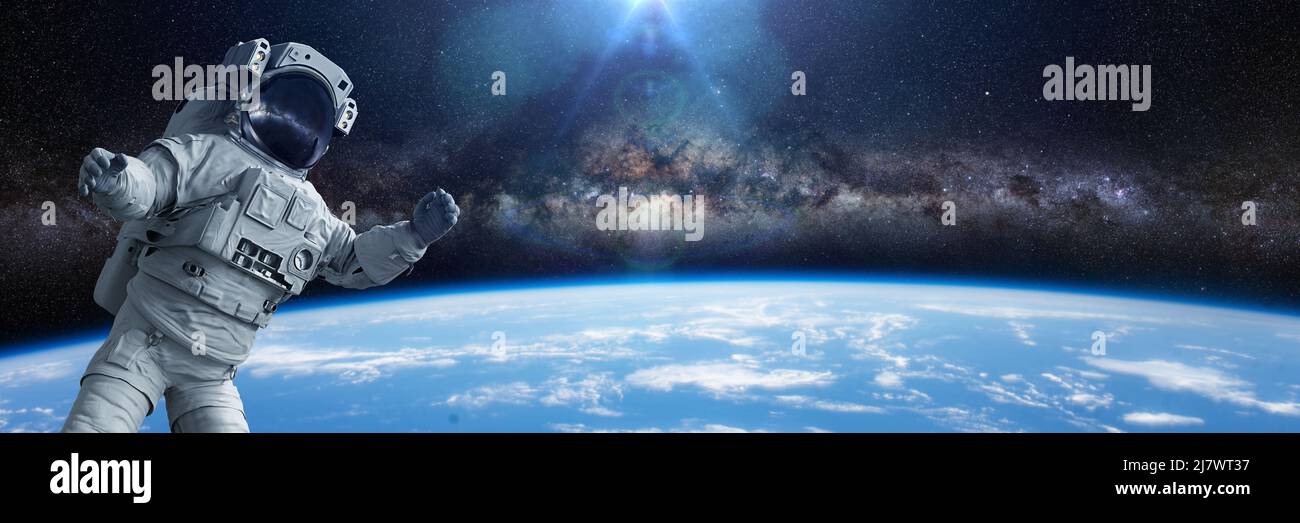 astronaut during a spacewalk in orbit of planet Earth, background ...