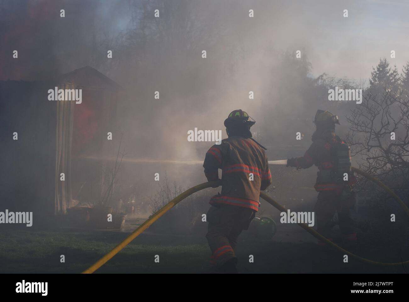 Firefighters Battling a Building Fire Stock Photo - Alamy