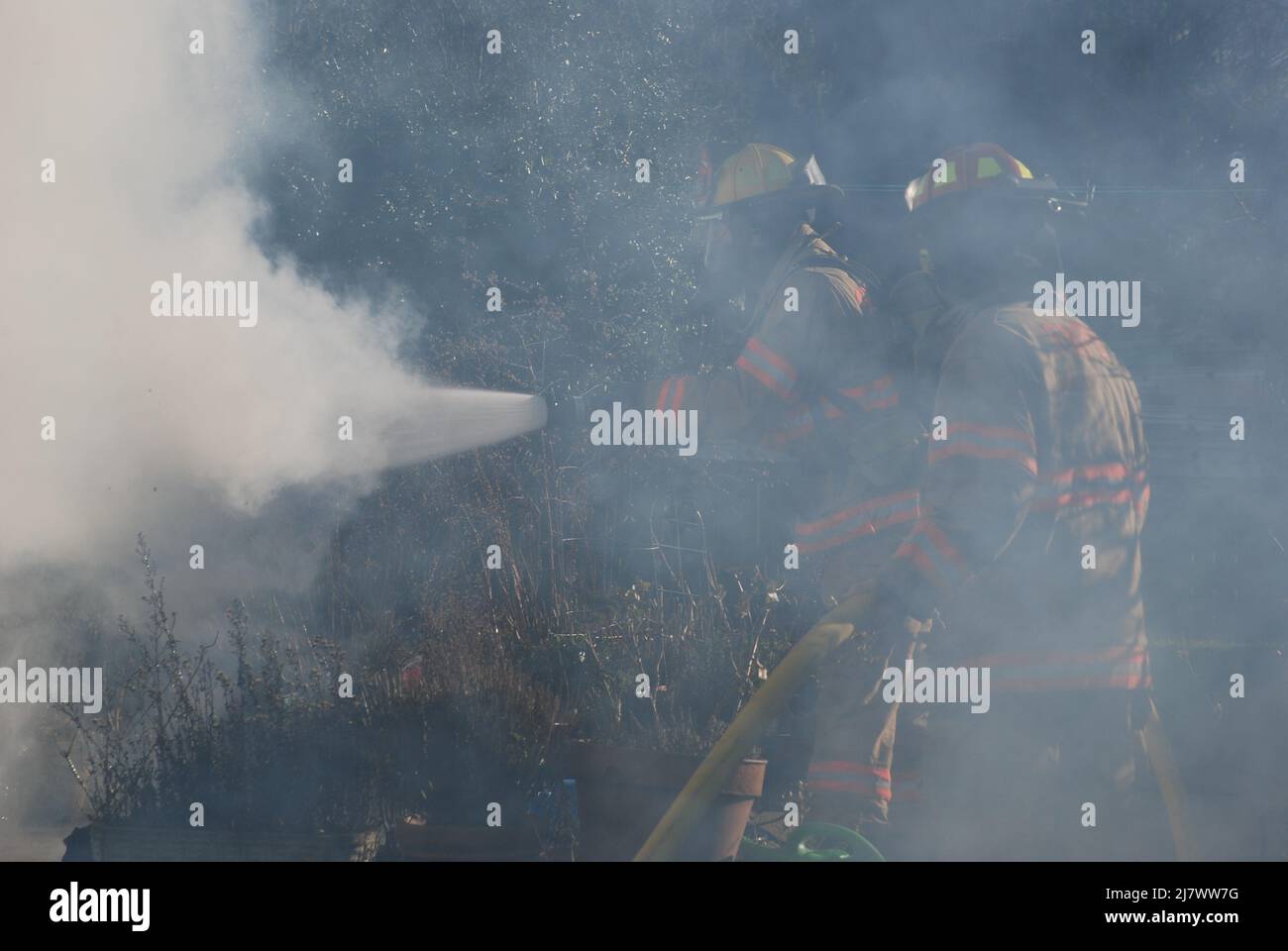 Firefighters Battling a Building Fire Stock Photo - Alamy