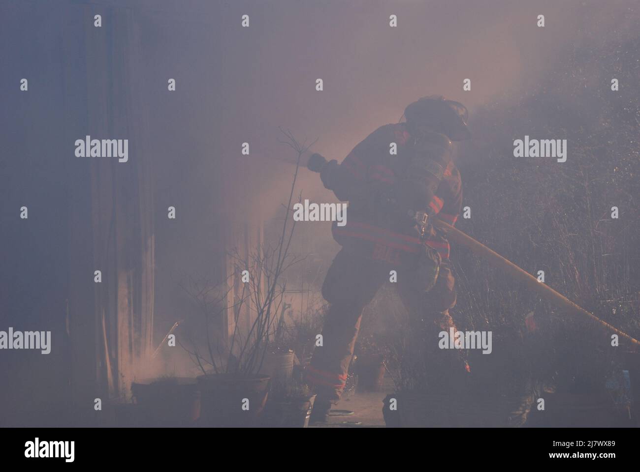 Firefighters Battling a Building Fire Stock Photo - Alamy