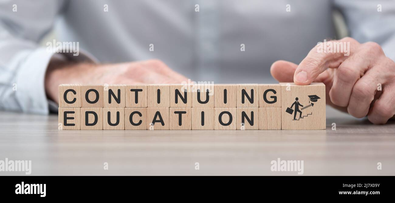 Wooden blocks with symbol of continuing education concept Stock Photo ...