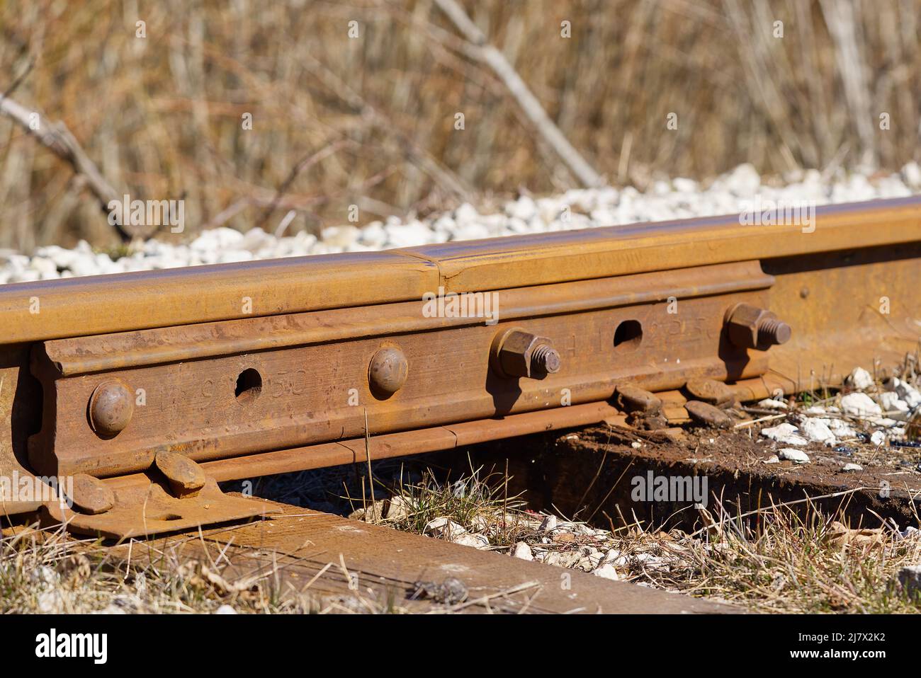 Connecting two rails. Train tracks underlay, rails and crushed stones ...