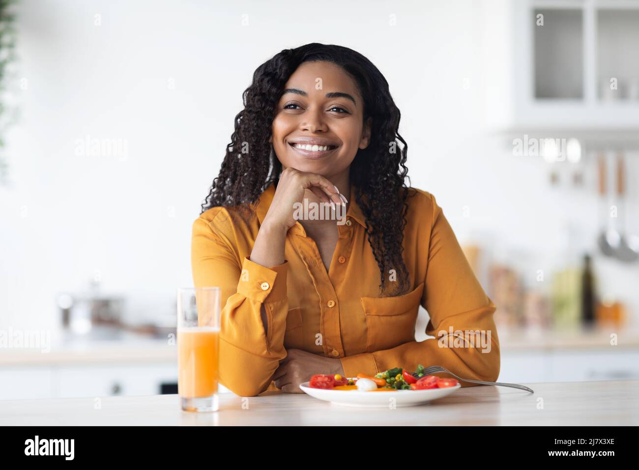 Happy young black woman having proper breakfast, kitchen interior Stock ...