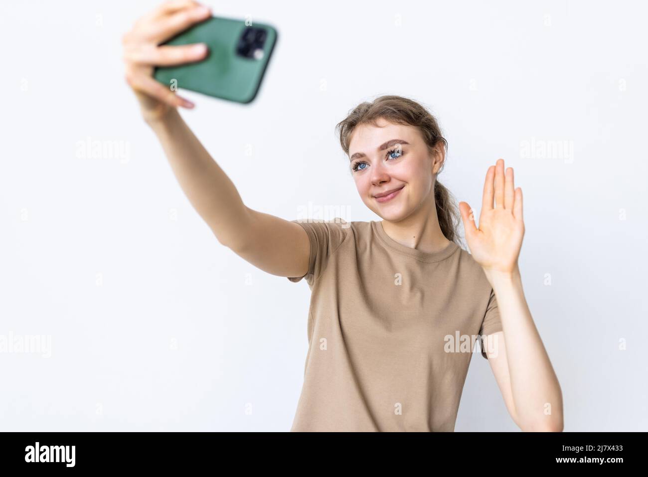 Happy young woman blogger influencer holding modern smart phone wave ...