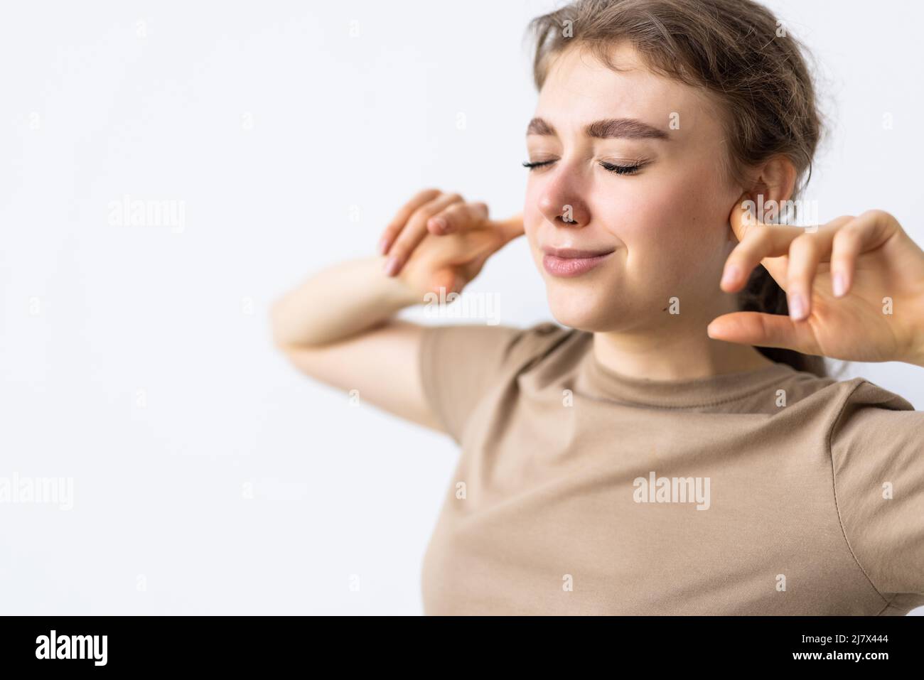 Close up portrait of angry stressed out young woman plugging ears with ...
