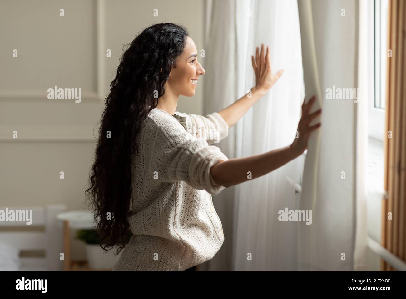 Woman open bedroom window hi-res stock photography and images - Alamy