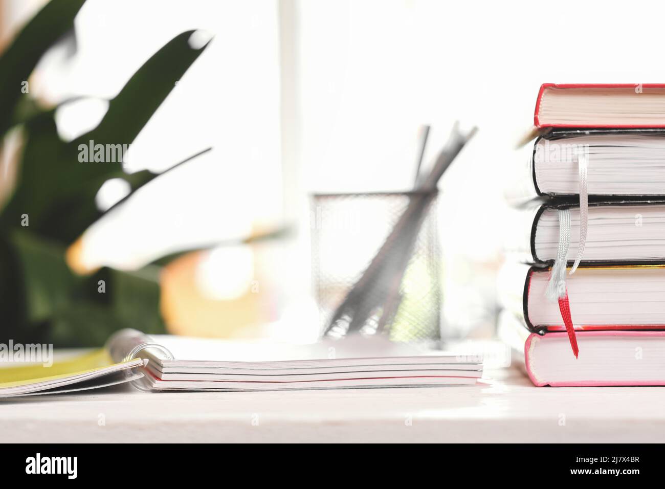 A stack of textbooks on the windowsill and writing stationary Stock ...