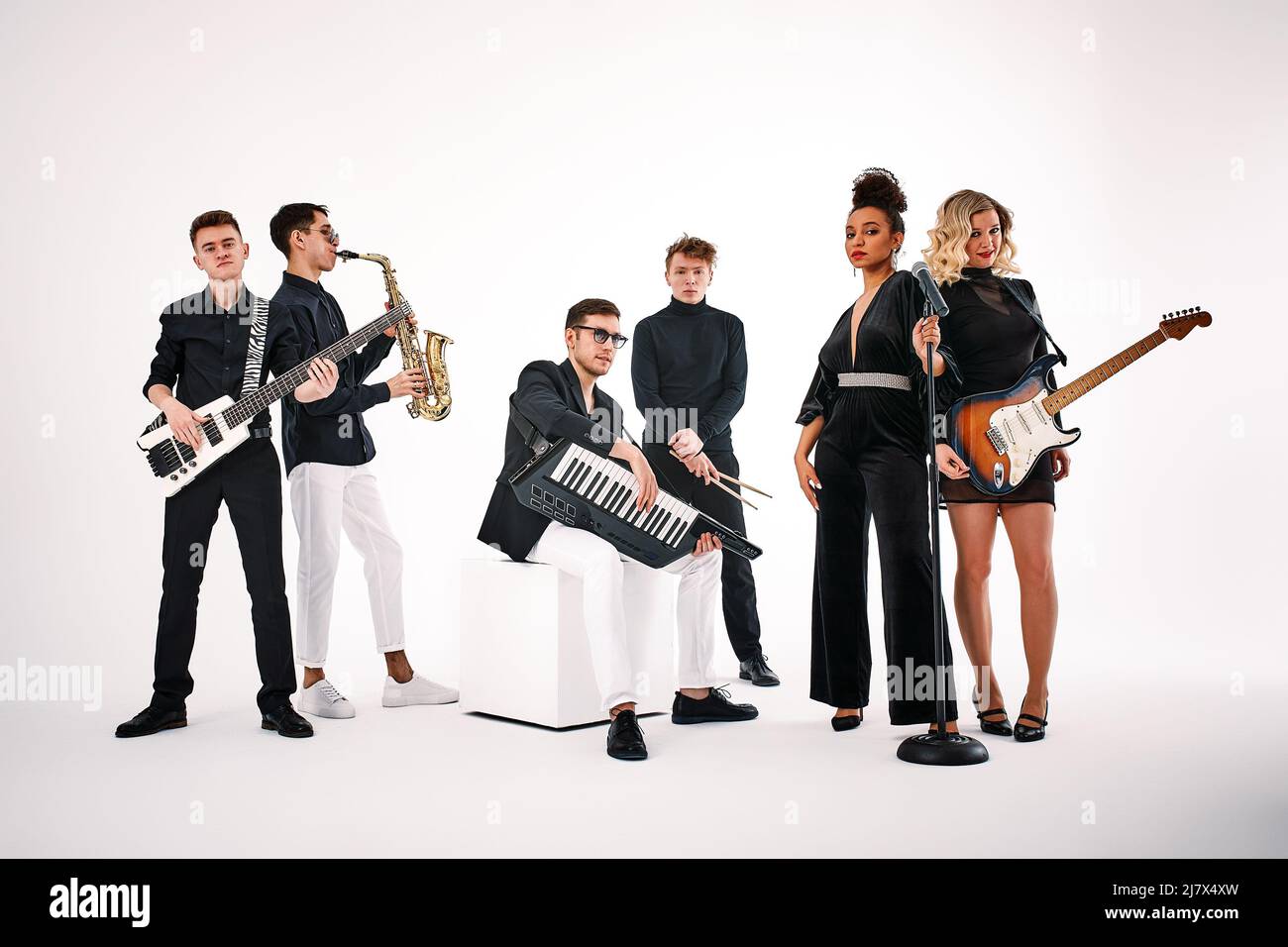 Portrait of diverse group of young people musical band playing with ...