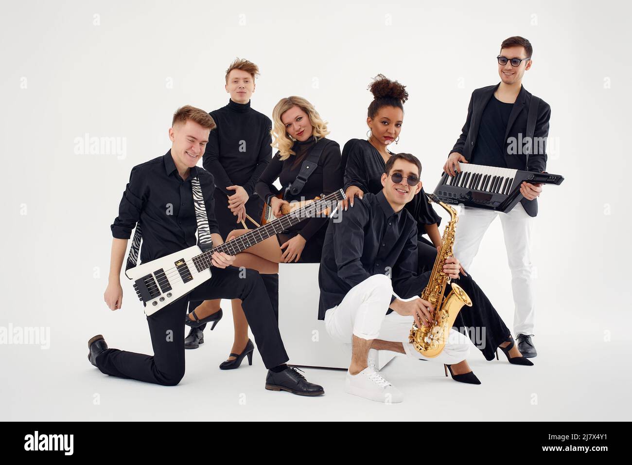 Portrait of diverse group of young people musical band playing with ...