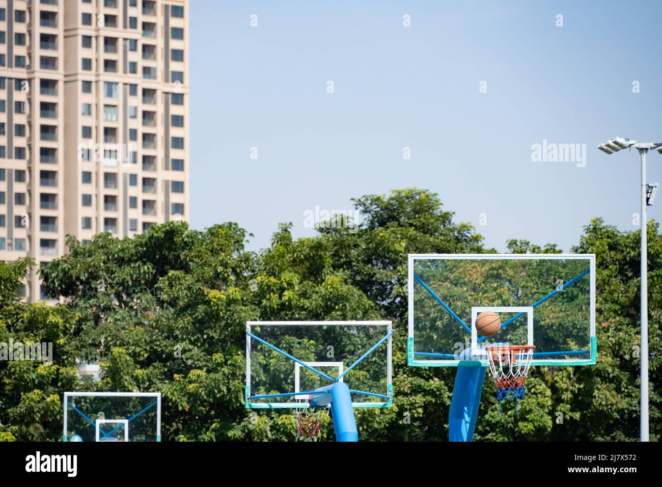 basketball hoops and boards in front of tall apartment building Stock ...