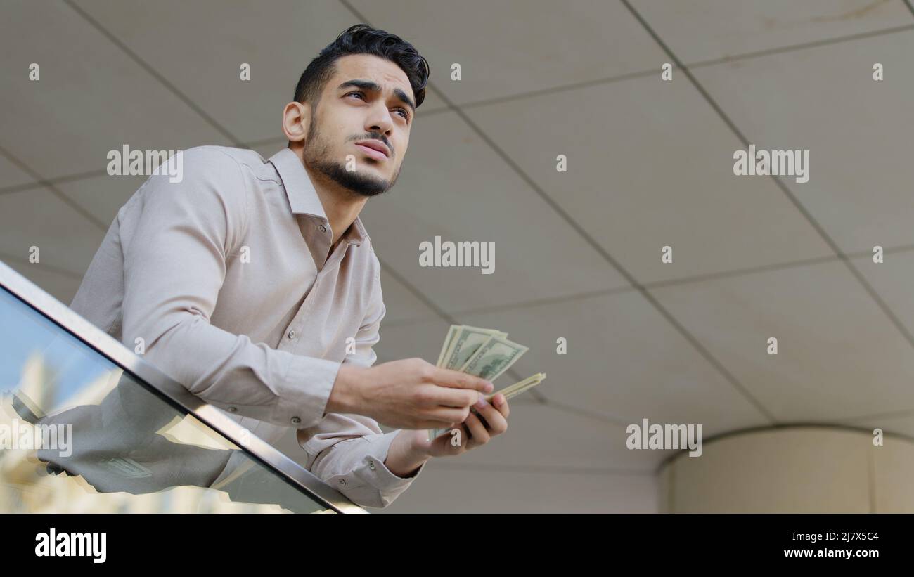 Pensive guy holding money hi-res stock photography and images - Alamy