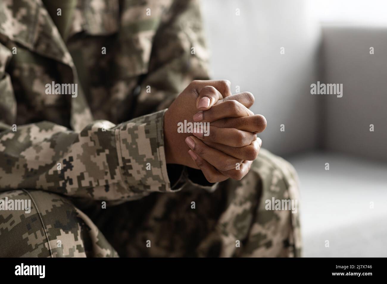 Unrecognizable Black Female Soldier Sitting On Couch With Clasped Hands ...