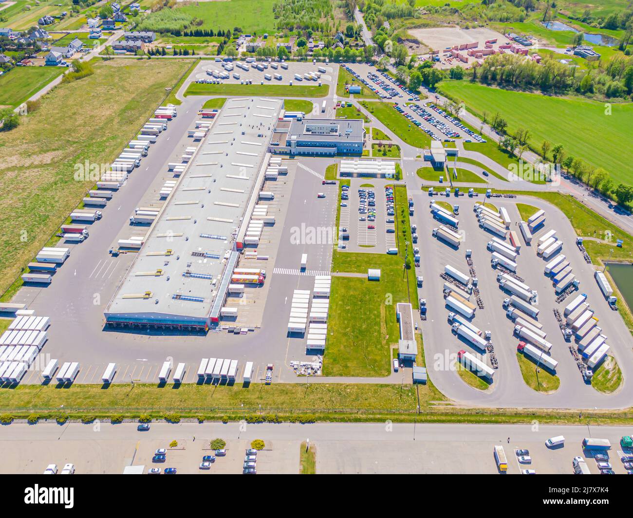Aerial Shot of Industrial Loading Area where Many Trucks Are Unloading ...