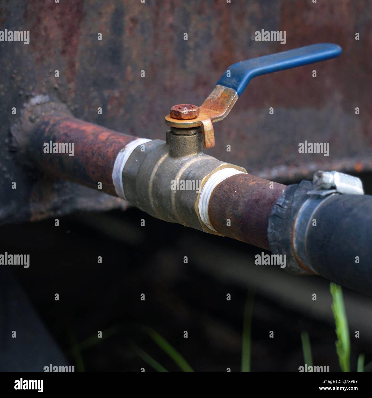 An old ball valve with a handle on a rusty tank Stock Photo - Alamy