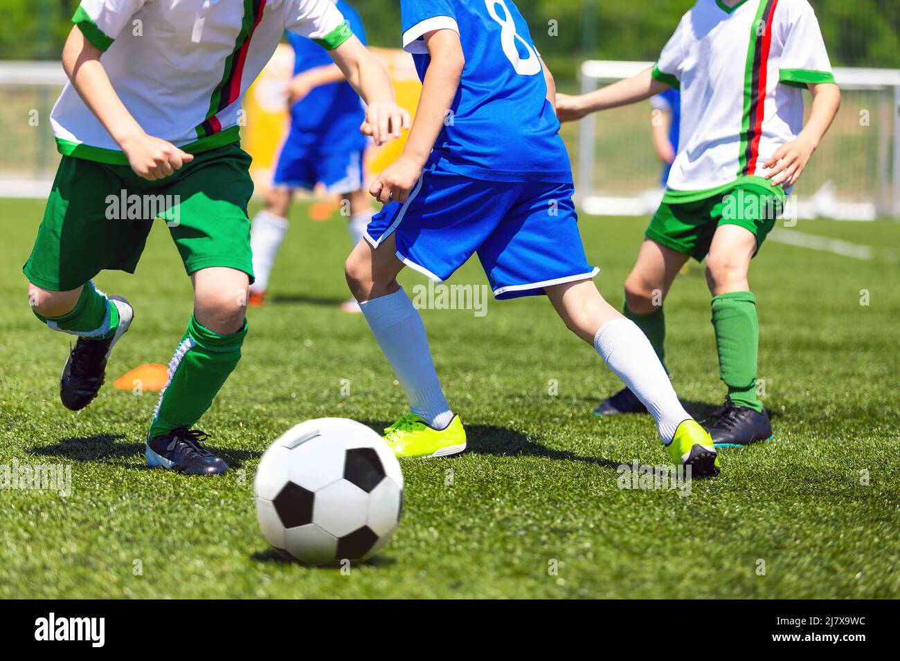 Boys play soccer. Teenagers at school playing soccer in sports field ...