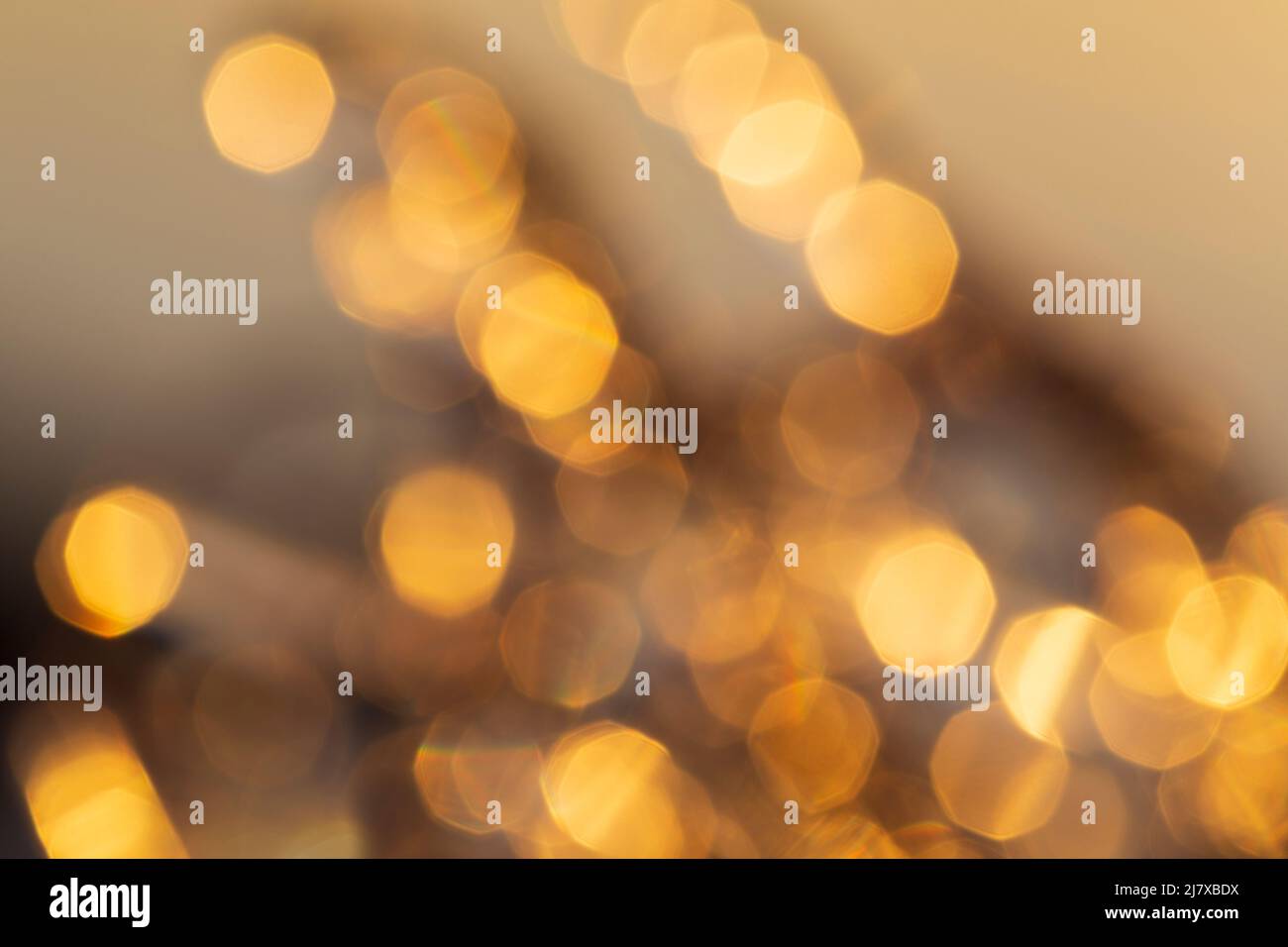 Defocused image of lights, golden hue. Layered golden bokeh spots. High ...