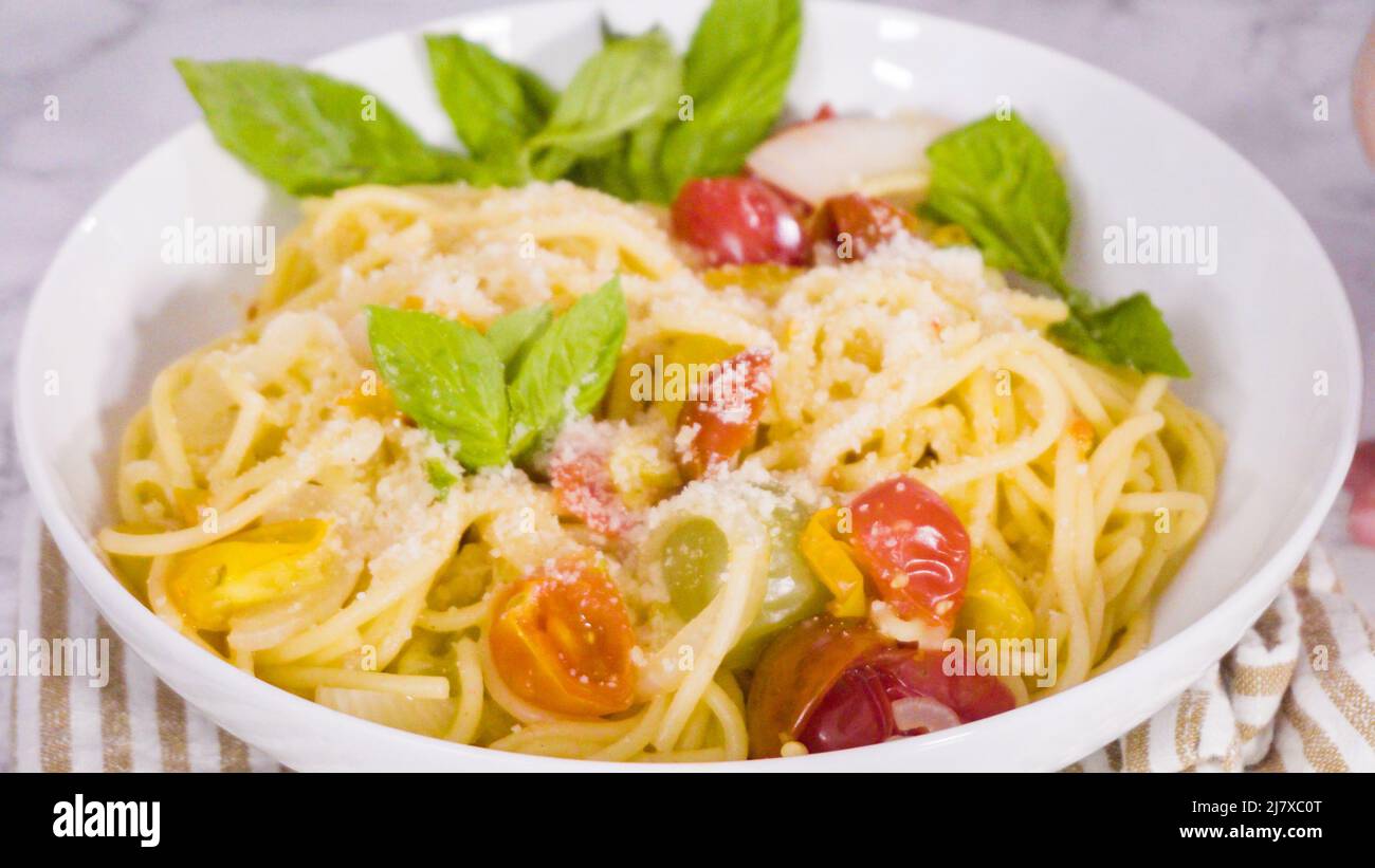 Step by step. Serving a one-pot pasta into a white pasta plate Stock ...