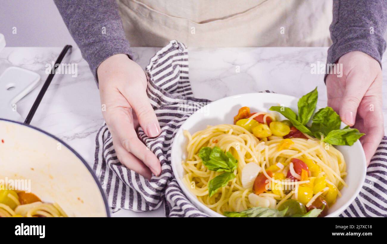 Step by step. Serving a one-pot pasta into a white pasta plate Stock ...