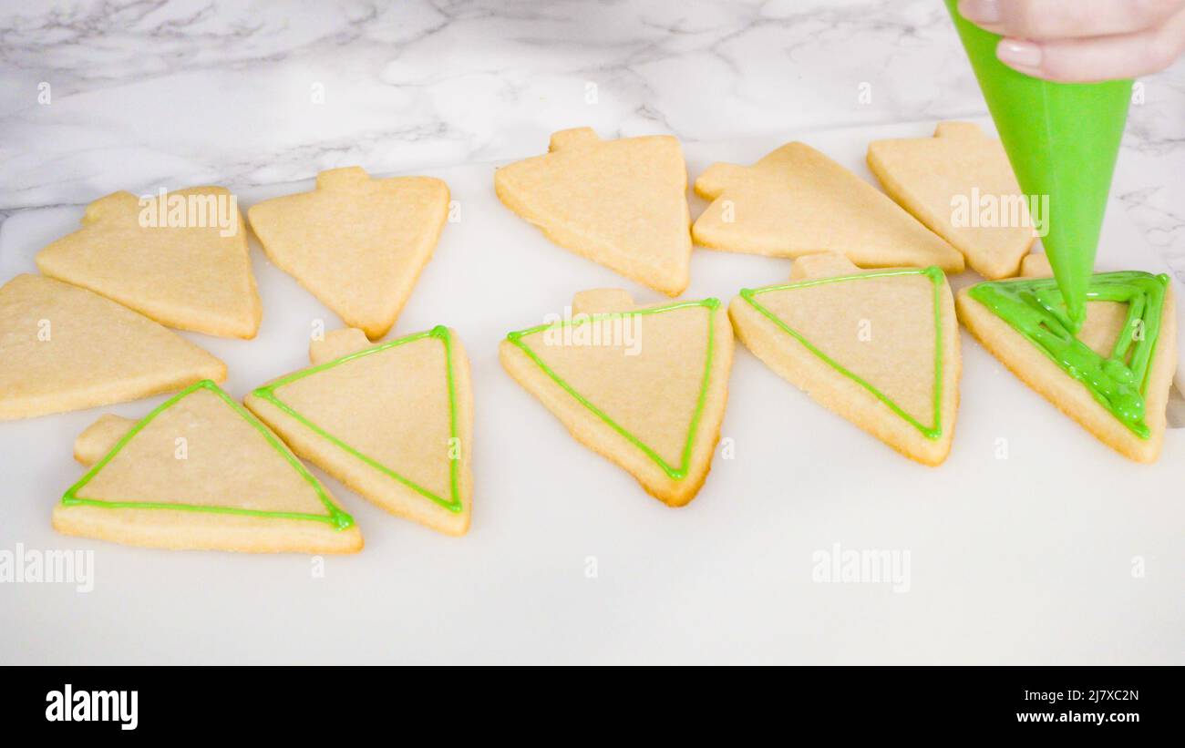 Stp by step. Icing Christmas tree-shaped sugar cookies with green royal ...